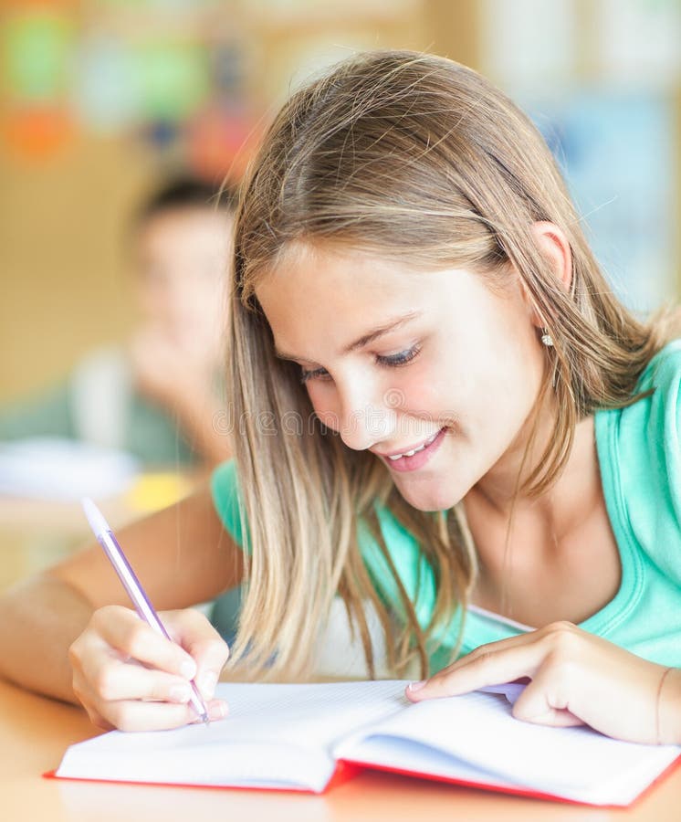 Young Girl Writing at School Stock Image - Image of background ...