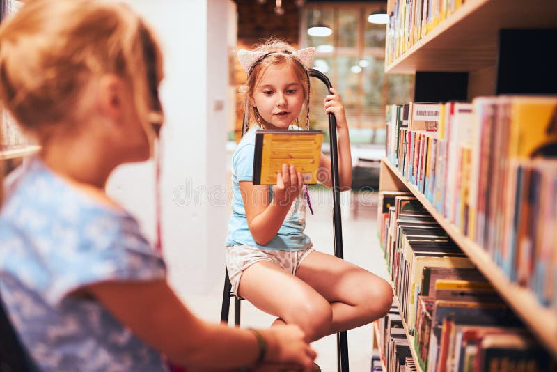 Schoolgirls Looking for Audio Books in School Library. Students ...