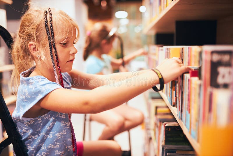 Schoolgirls Looking for Book for Reading in School Library. Students ...