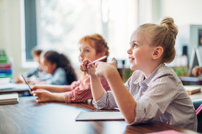 Concentrated Beautiful Schoolgirls Sitting Stock Image - Image of ...