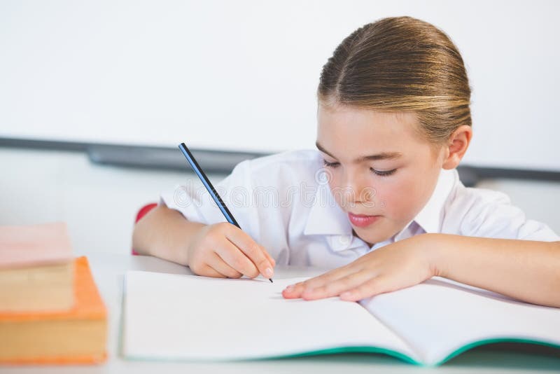 Schoolkid Doing Homework in Classroom Stock Photo - Image of school ...