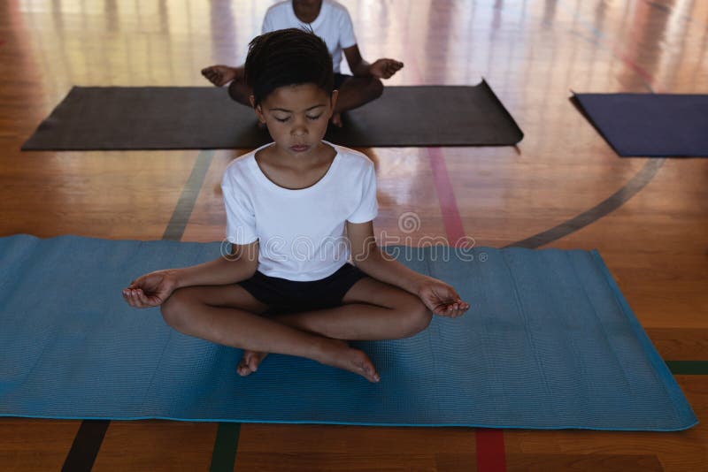 Schoolkids Doing Yoga and Meditating on a Yoga Mat in School Stock ...