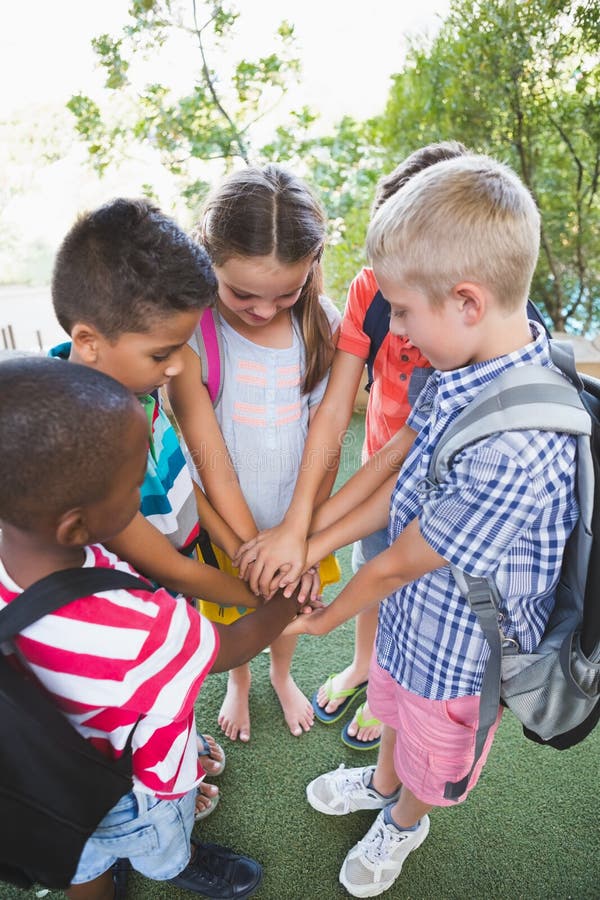 Schoolkids Putting Their Hands Together in Campus Stock Photo - Image ...