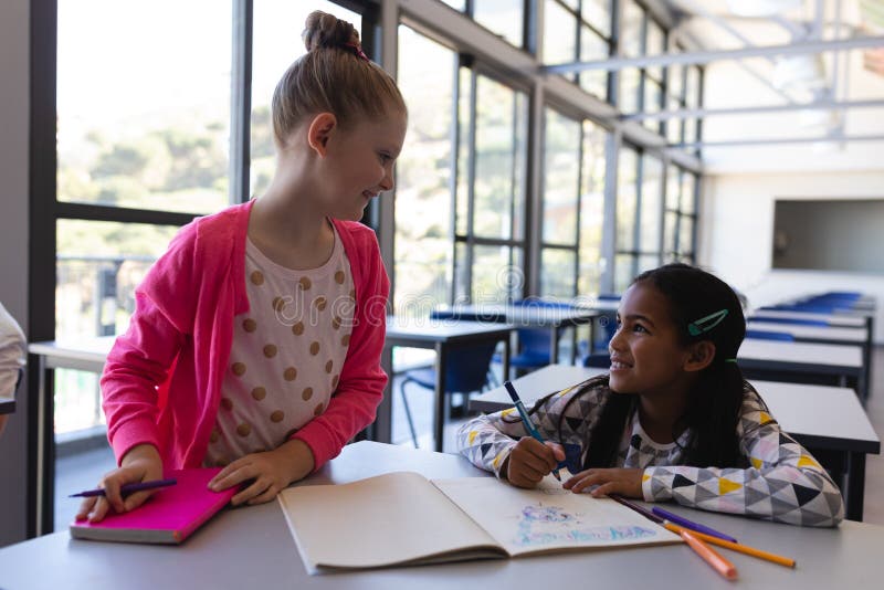 Schoolkids Talking with Each Other at Desk in Classroom Stock Image ...