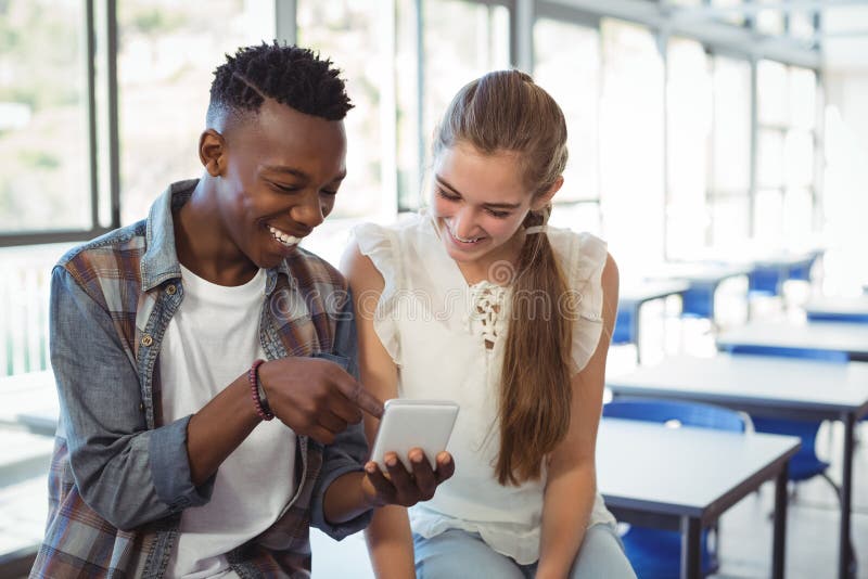 Schoolkids Using Mobile Phone in Classroom Stock Photo - Image of ...