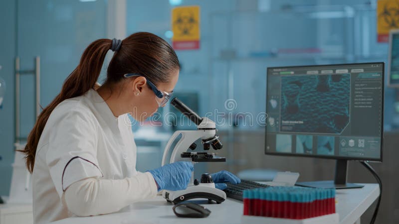 Science Engineer Using Microscope To Analyze Dna Sample Stock Photo ...