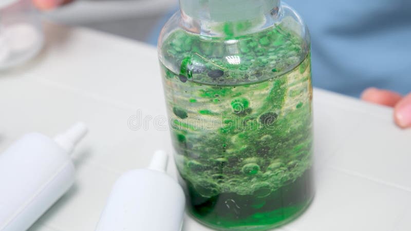 Science Experiment in Laboratory. Chemist Analyzing Red, Yellow, Blue ...