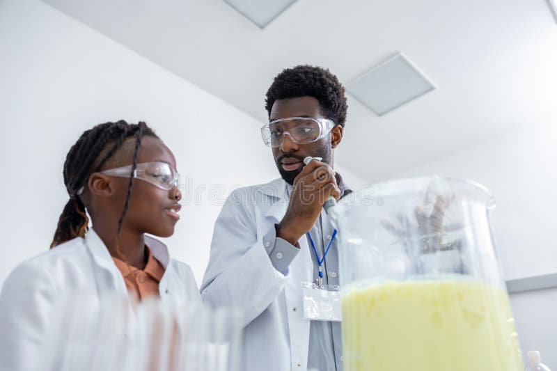 Teacher and Student Working in a School Laboratory and Looking Involved ...