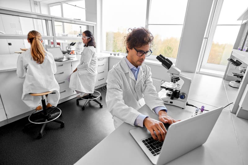 Scientists with Microscopes Working in Laboratory Stock Image - Image ...