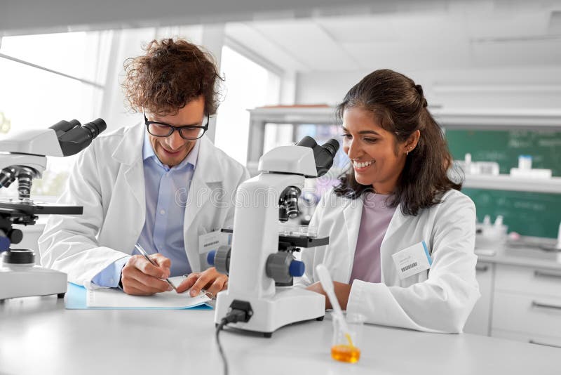 Scientists with Microscopes Working in Laboratory Stock Image - Image ...