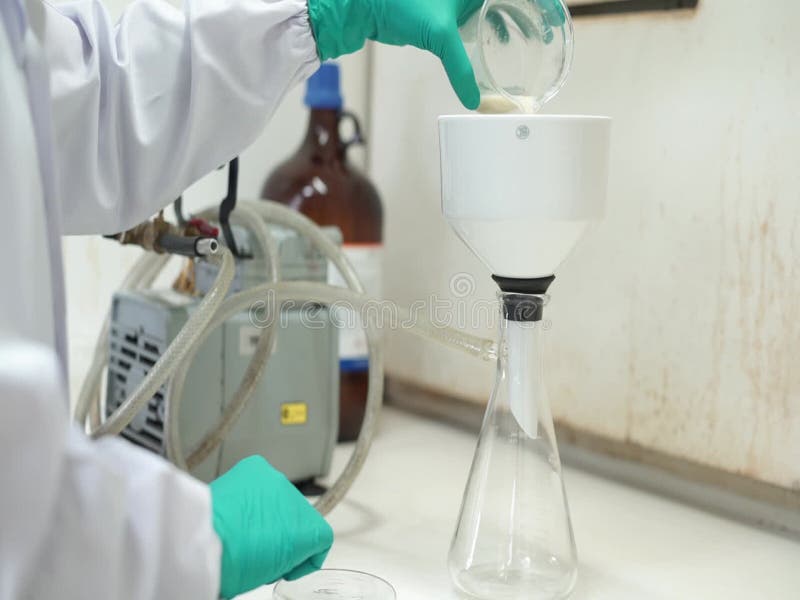 A Science Researcher Doing Filtration for Extraction of Compound Stock ...