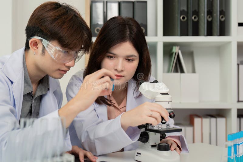Science Researchers Conducting Microscope Experiments - Concept of ...