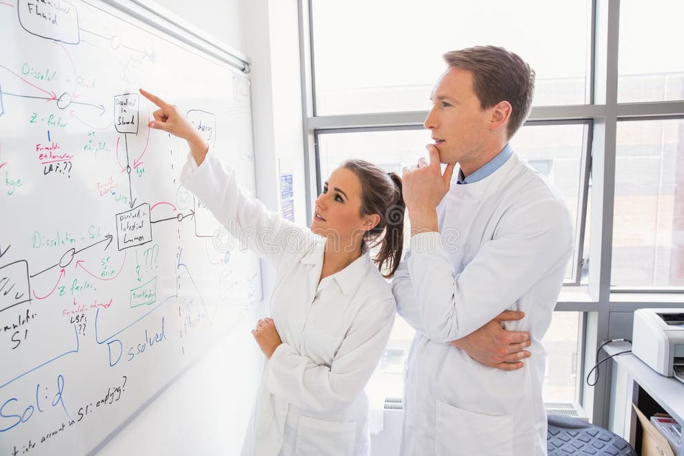 Science Student and Lecturer Looking at Whiteboard Stock Image - Image ...