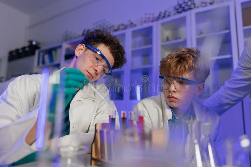 Science Students Doing Chemical Experiment in the Laboratory at ...