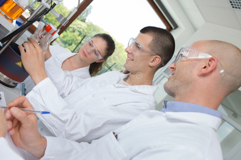 Science Students Performing Experiment Stock Photo - Image of research ...