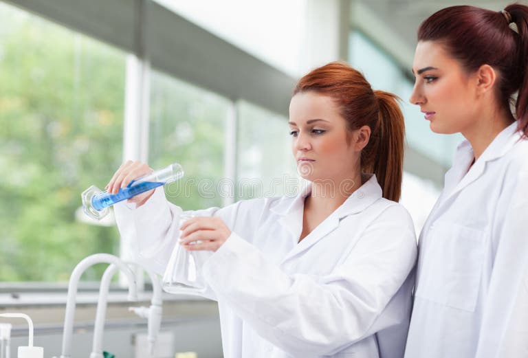 Science Students Pouring Liquid in an Flask Stock Image - Image of ...