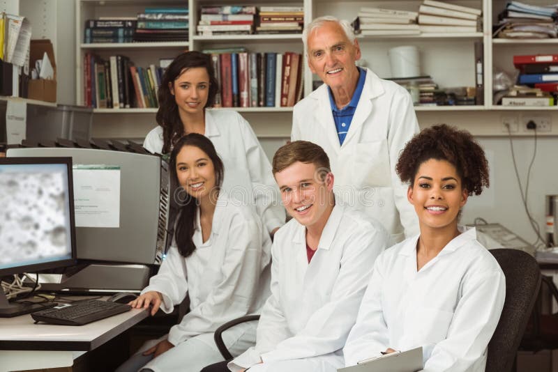Science Students Smiling at Camera with Professor Stock Image - Image ...