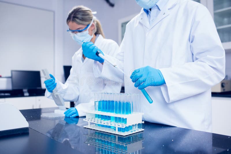 Science Students Using Pipettes To Fill Test Tubes Stock Image - Image ...
