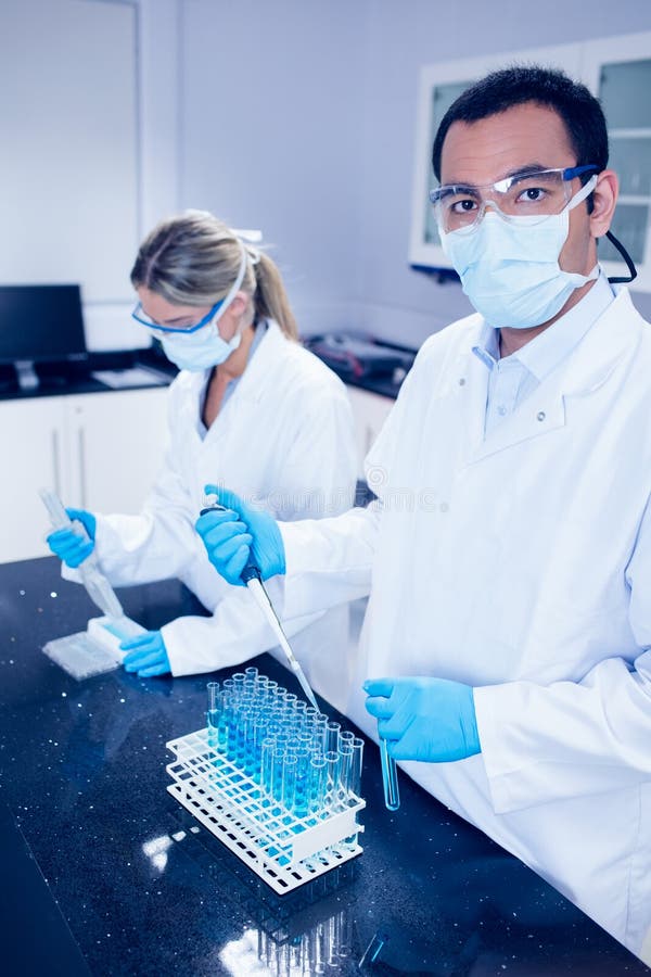 Science Students Using Pipettes To Fill Test Tubes Stock Image - Image ...