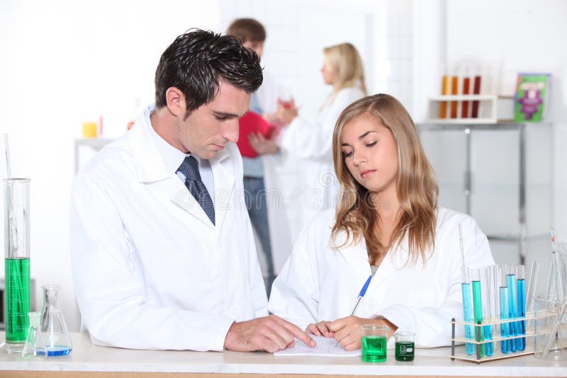 Science Teacher Helping Student Stock Photo - Image of helping ...
