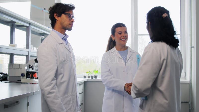 Scientists Shaking Hands in Laboratory Stock Video - Video of ...