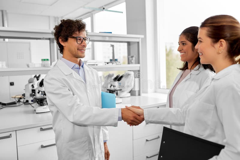 Scientists Shaking Hands in Laboratory Stock Image - Image of hiring ...