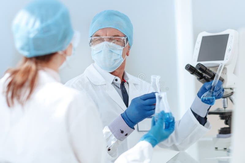 Scientific Colleagues Discuss Sitting at the Laboratory Table. Stock ...