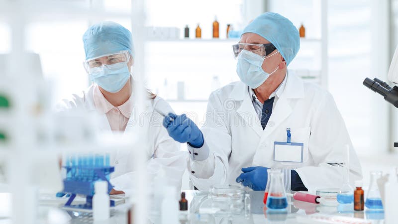 Scientific Colleagues Discuss Sitting at the Laboratory Table. Stock ...
