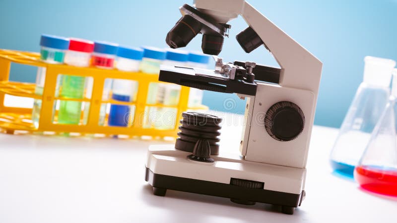 Scientific Experiment in School Class. Microscope and Test Tubes on the ...