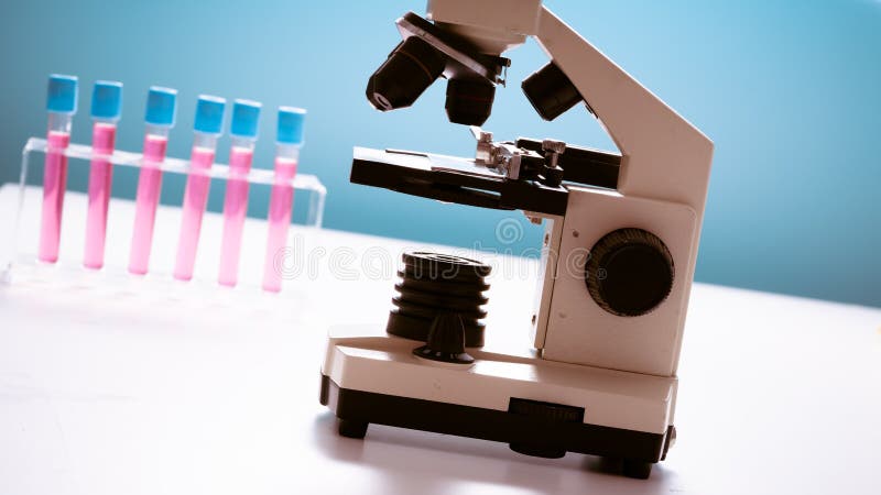 Scientific Experiment in School Class. Microscope and Test Tubes on the ...