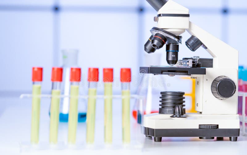 Scientific Experiment in School Class. Microscope and Test Tubes on the ...