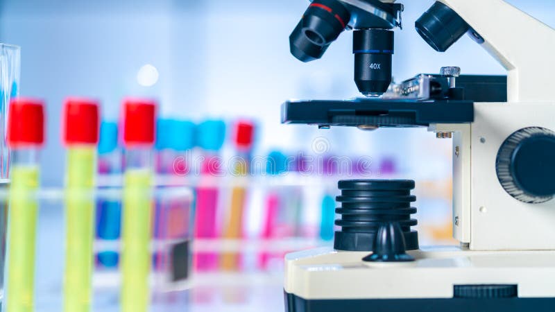 Scientific Experiment in School Class. Microscope and Test Tubes on the ...