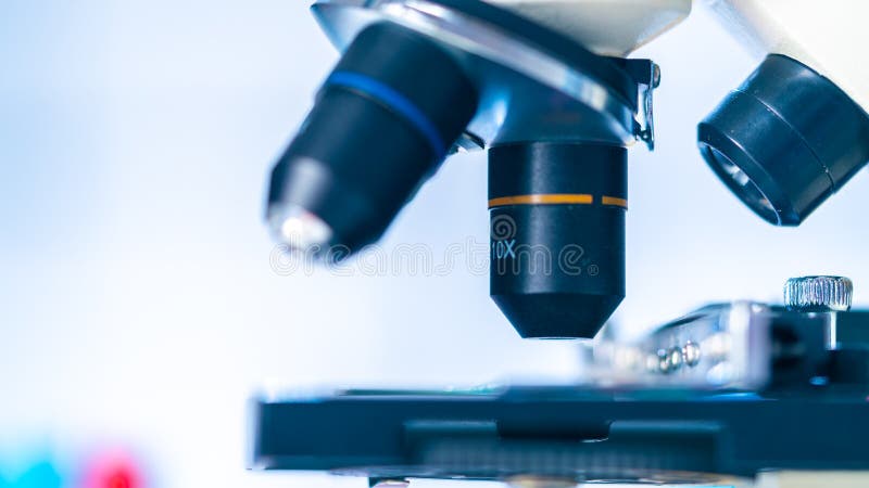 Microscope Table with a Luminous Slide and a Microscope Lens on a Dark ...