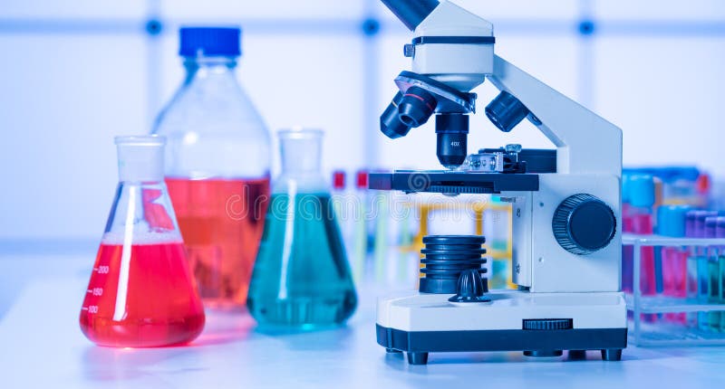 Scientific Experiment in School Class. Microscope and Test Tubes on the ...