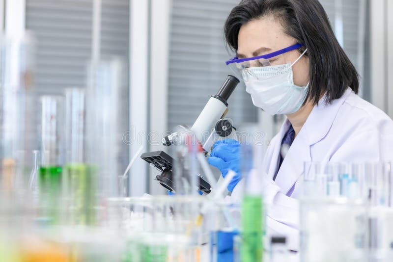 Female Scientis with Protection Gear Working in a Microbiology Research ...