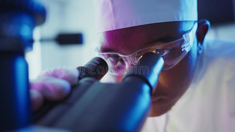 Scientist Analyzing Sample with Microscope in Laboratory Stock Footage ...