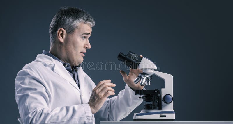 Scientist Analyzing Samples Under the Microscope Stock Photo - Image of ...