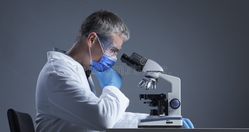 Scientist Analyzing Samples Under the Microscope Stock Image - Image of ...