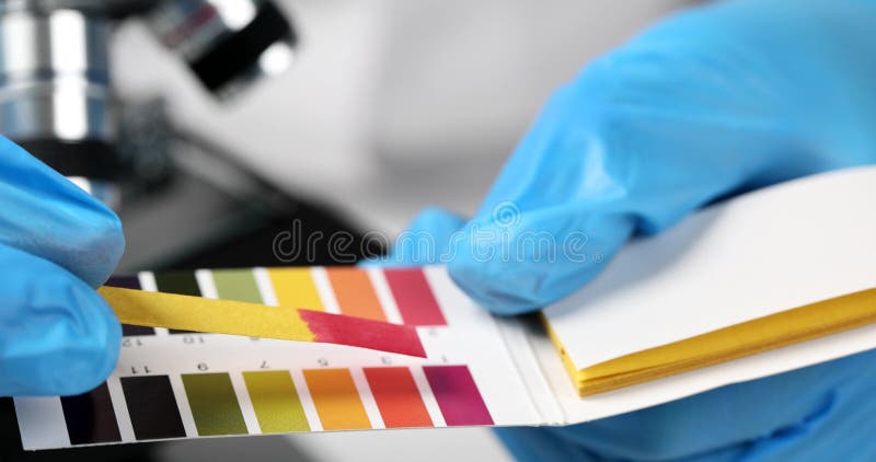 Scientist Chemist Holding Ph Test in Hands and Comparing Result Closeup ...