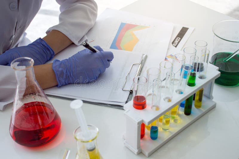 Scientist Chemist Take Notes with a Red Liquid Chemical Solution Making ...