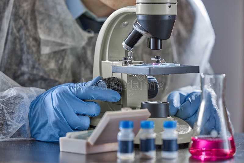 Scientist, Chemist Working with Microscope in Pharmaceutical Laboratory ...