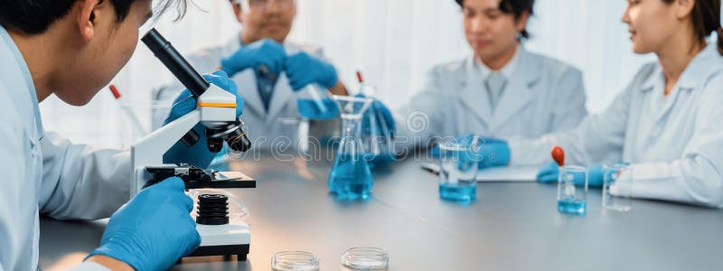 Scientist Conduct Chemical Experiment Using Microscope in Medical Lab ...