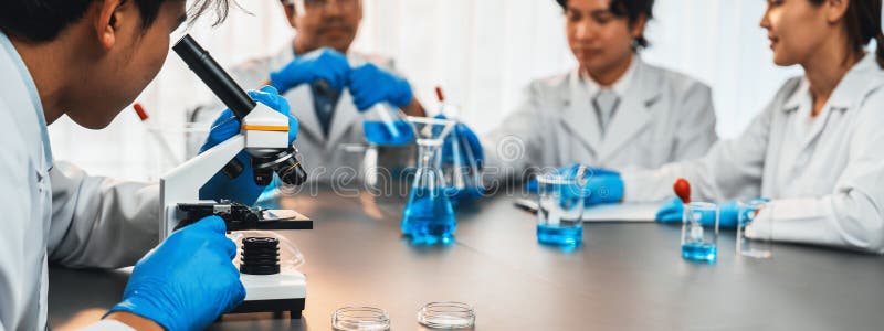 Scientist Conduct Chemical Experiment Using Microscope in Medical Lab ...