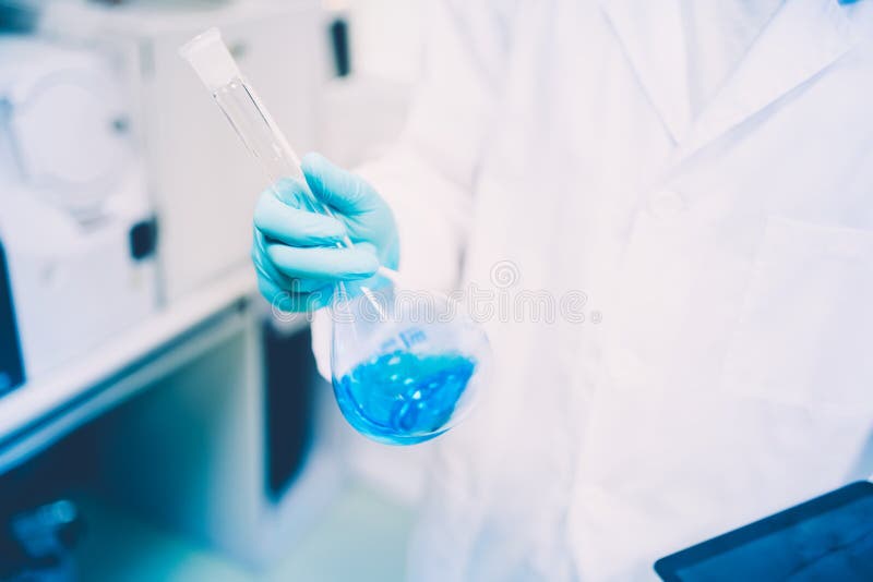 Scientist Conducting Experiments in Chemical Laboratory with Liquid ...