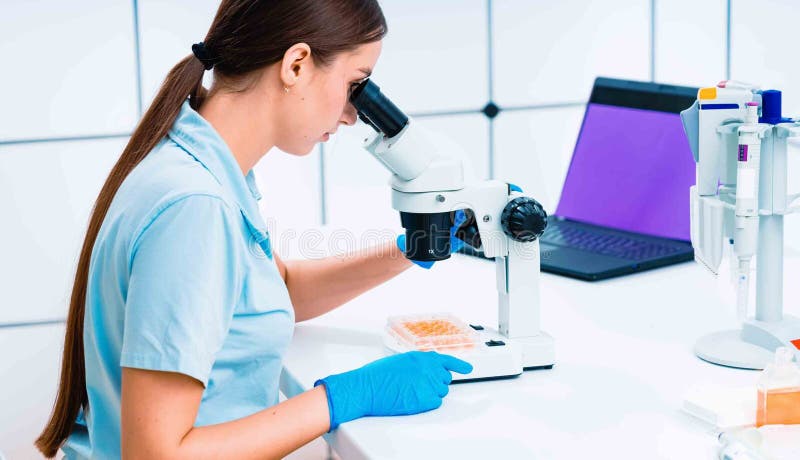 Scientist Conducting Scientific Experiment with Microscope in ...