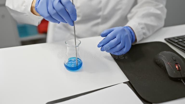A Scientist Conducts an Experiment with a Blue Liquid in a Laboratory ...