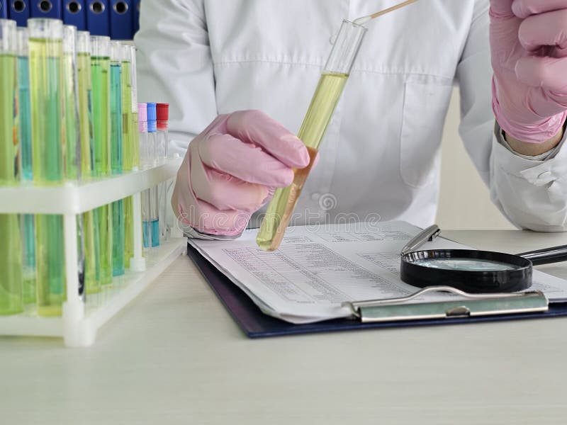 Scientist Conducts Experiment with Test Tubes and Magnifying Glass in ...