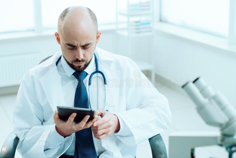 Scientist with a Digital Tablet Sitting at a Laboratory Table. Stock ...