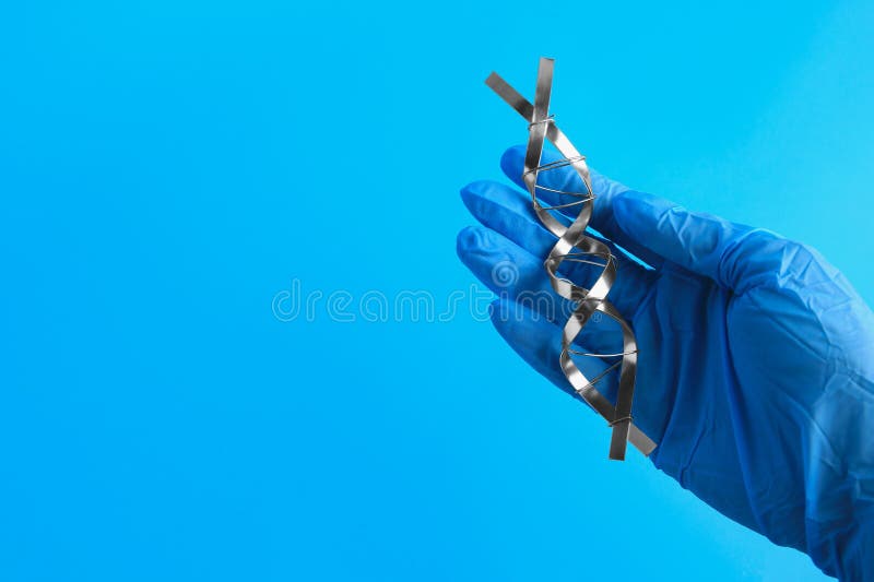 Scientist with DNA Molecular Chain Model Made of Metal on Blue ...