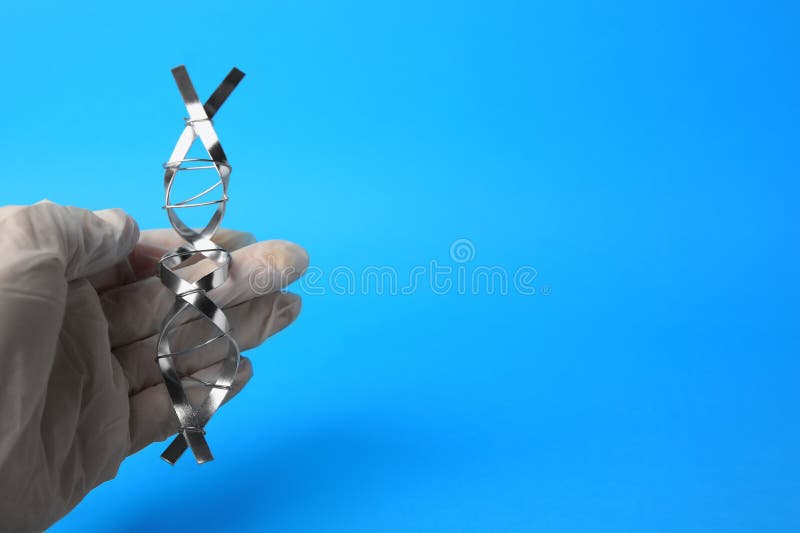 Scientist with DNA Molecular Chain Model Made of Metal on Blue ...
